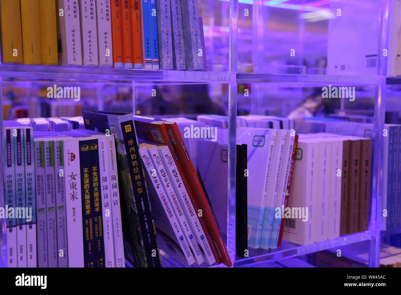 Books are lined up on shelves in the new library at Sias International ...