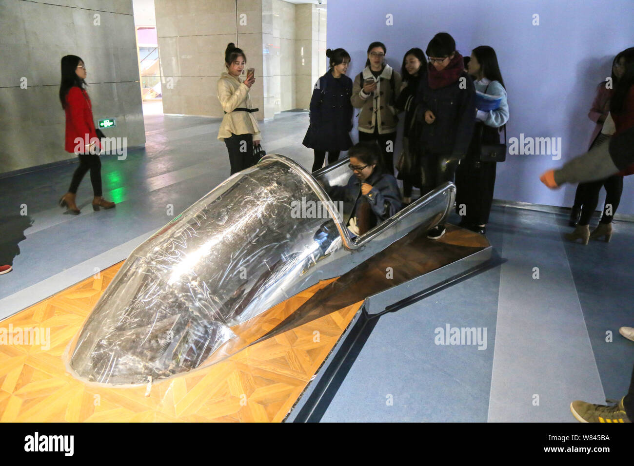 A Chinese student tries out a slide in the new library at Sias ...