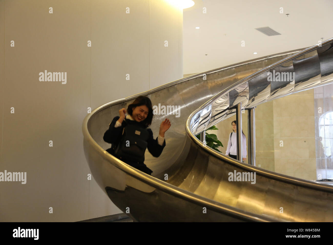 A Chinese student tries out a slide in the new library at Sias ...