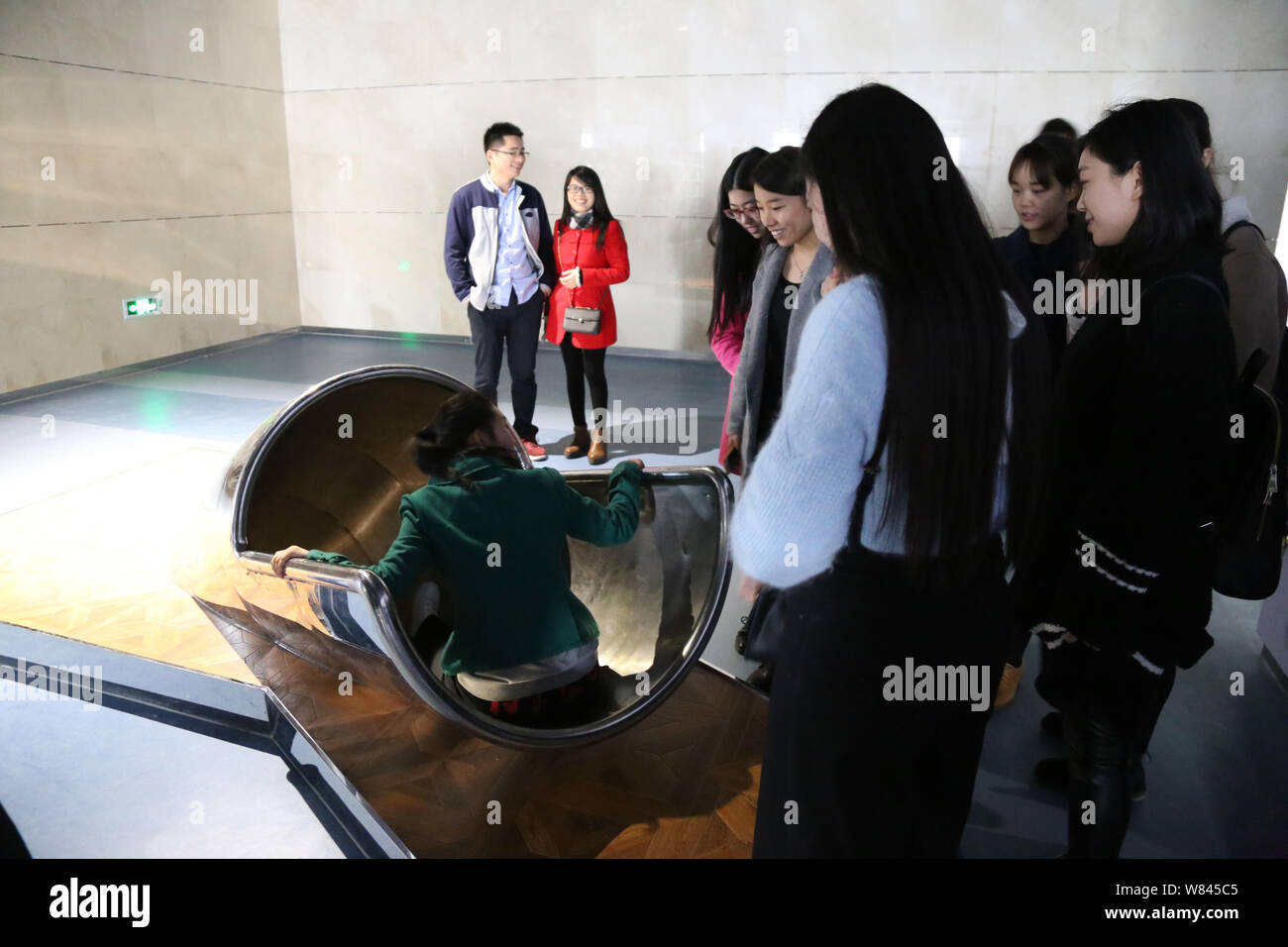 A Chinese student tries out a slide in the new library at Sias ...