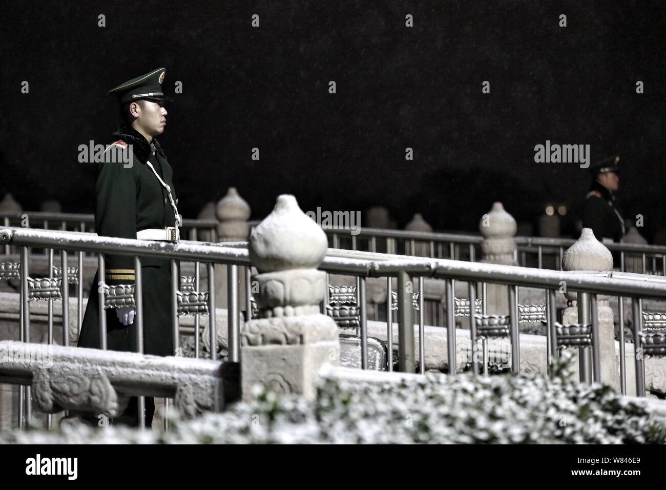 A Chinese paramilitary policeman stands guard in front of the Tian ...