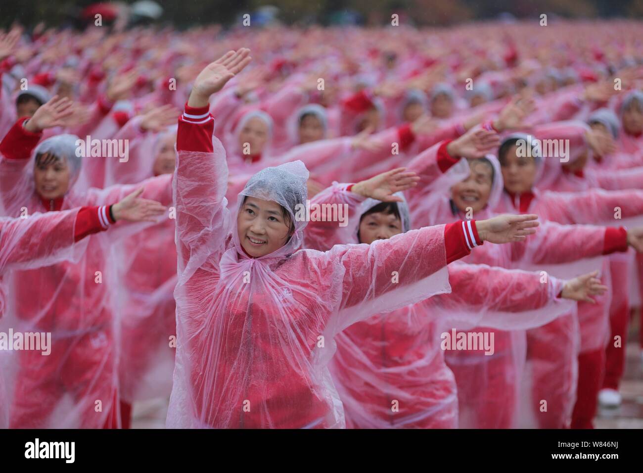 Local Chinese residents wearing raincoats perform square dance in the ...