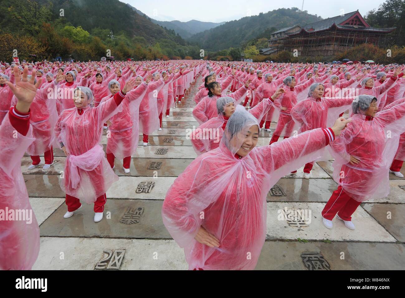 Local Chinese residents wearing raincoats perform square dance in the ...