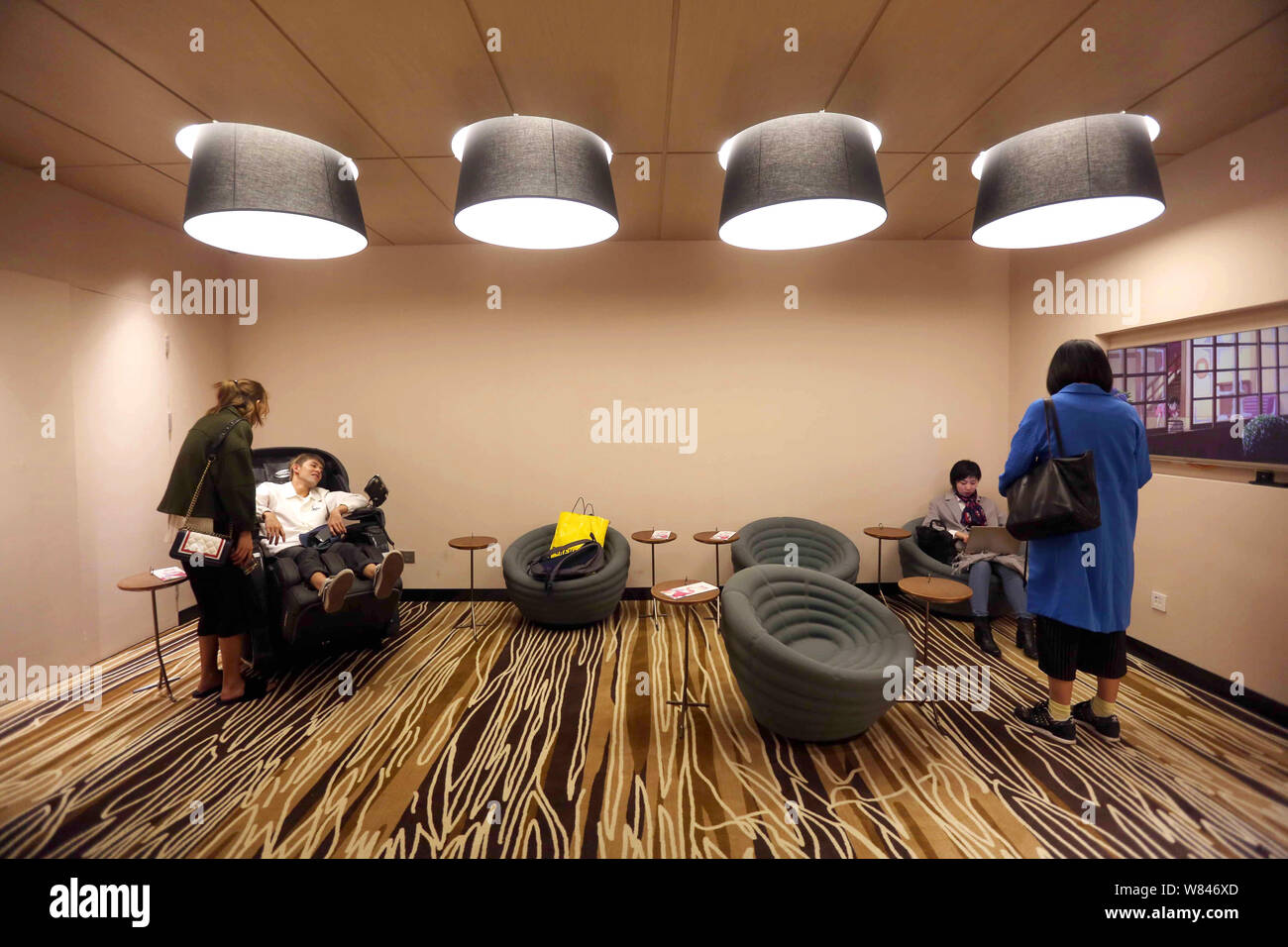 Shoppers rest in the husband nursery at Vanke Mall in Qibao town ...