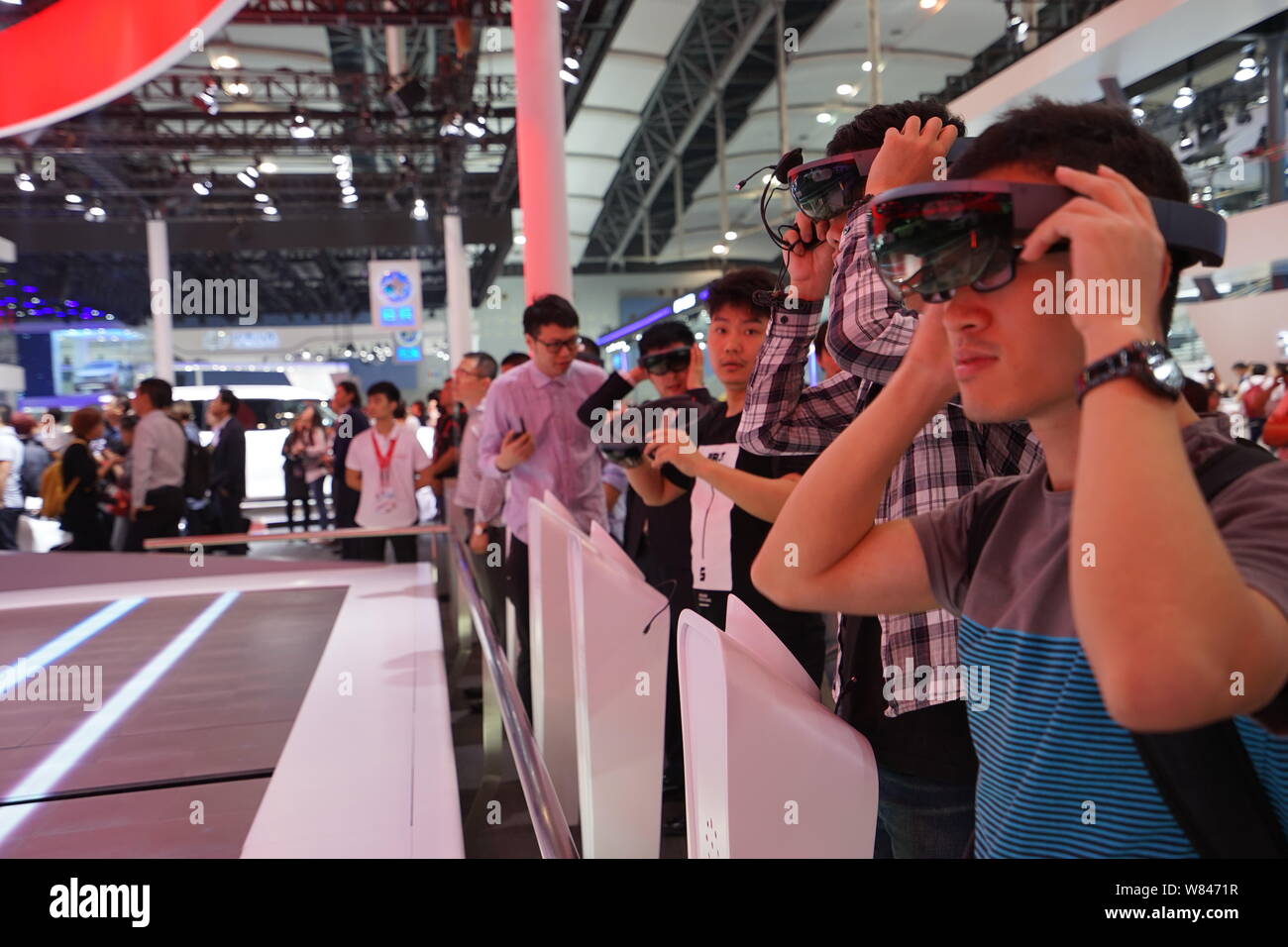Visitors try out virtual reality (VR) devices during the 14th China ...