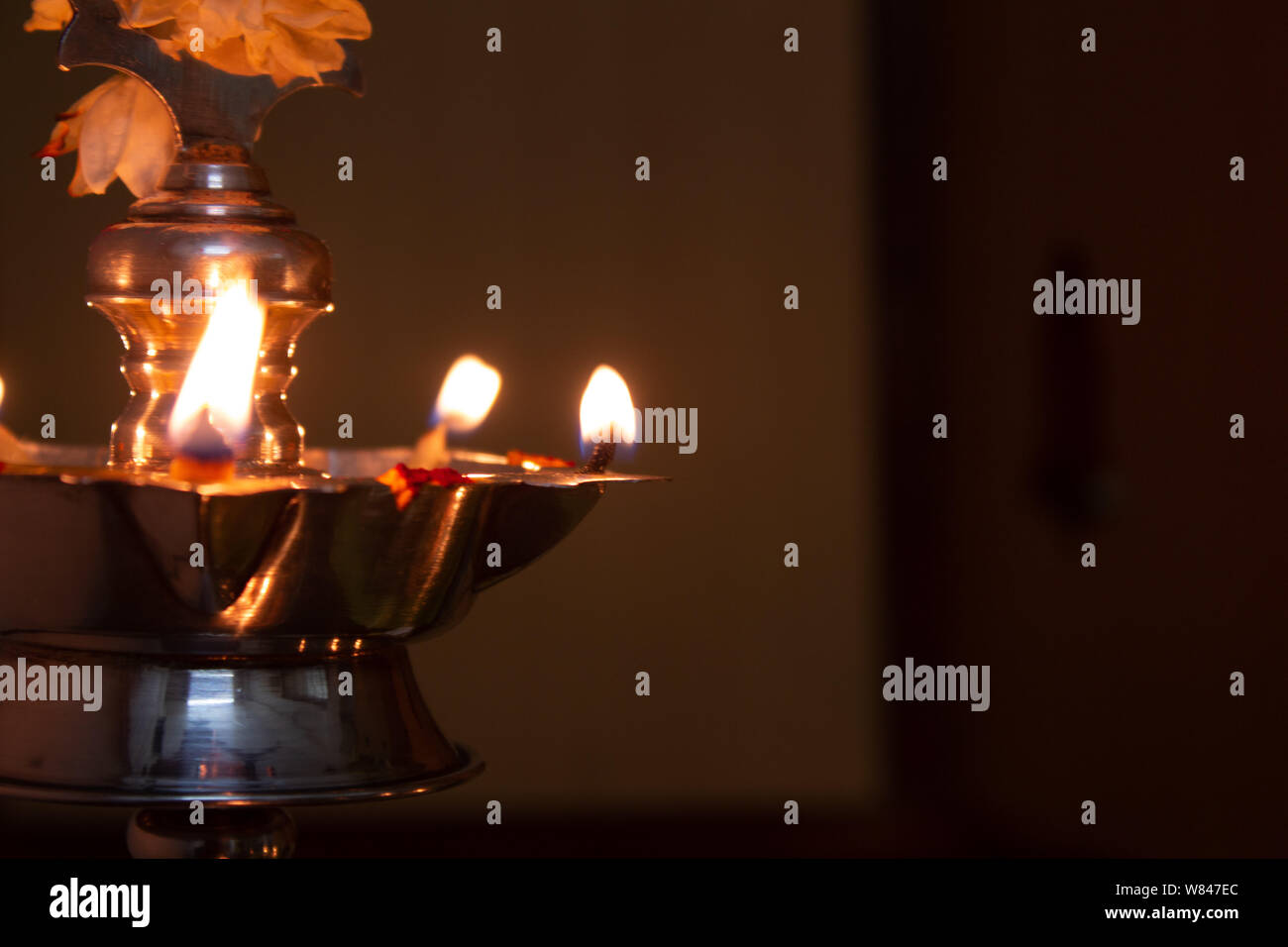 Lamps lit during the prayers to god along with food offering Stock ...