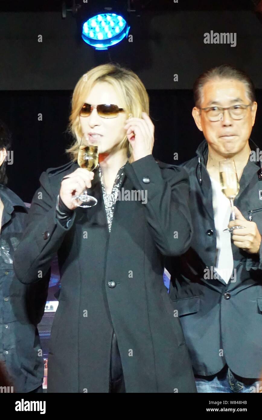 Yoshiki Hayashi, left, of Japanese rock band X Japan speaks at a press ...