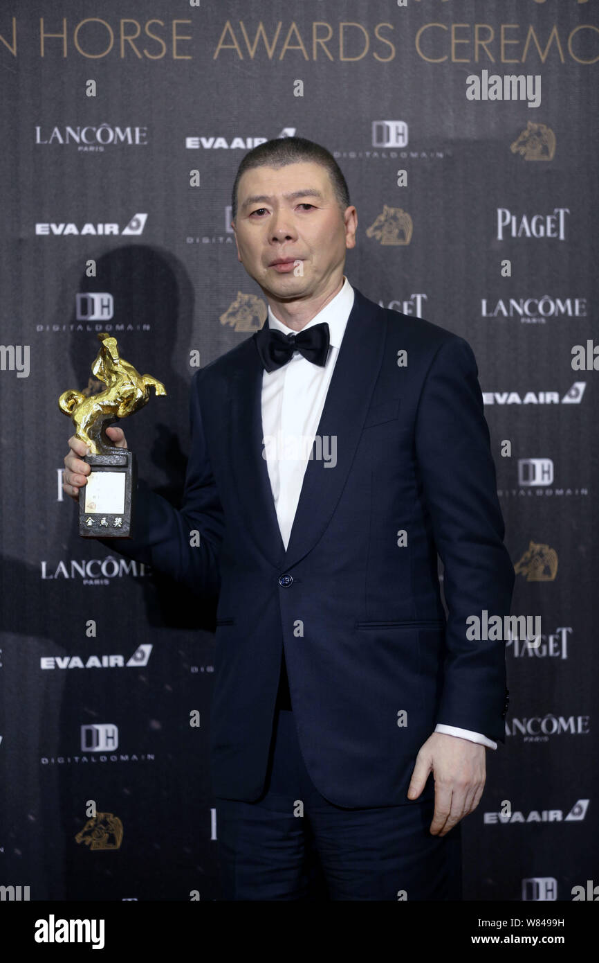 Chinese director Feng Xiaogang poses with his trophy of the Best ...