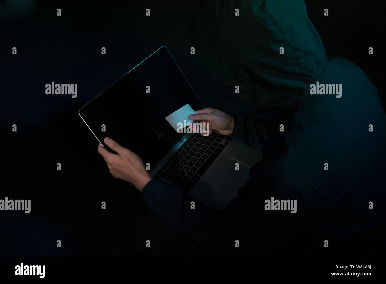 Hacker behind computer hi-res stock photography and images - Alamy