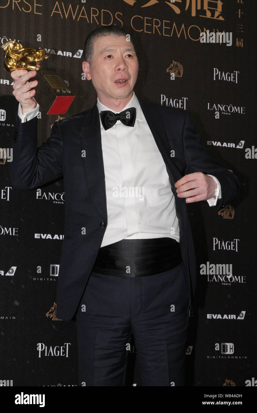 Chinese director Feng Xiaogang poses with his trophy of the Best ...