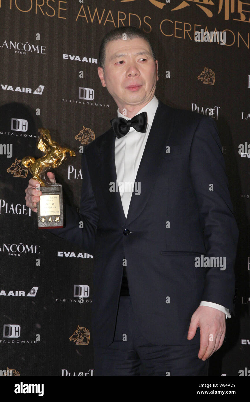 Chinese director Feng Xiaogang poses with his trophy of the Best ...