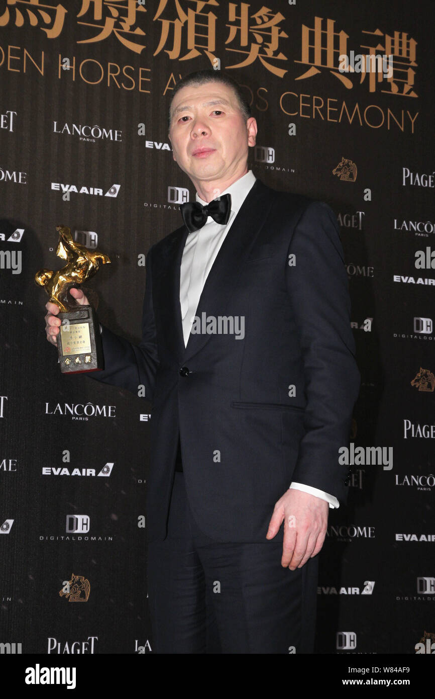 Chinese director Feng Xiaogang poses with his trophy of the Best ...