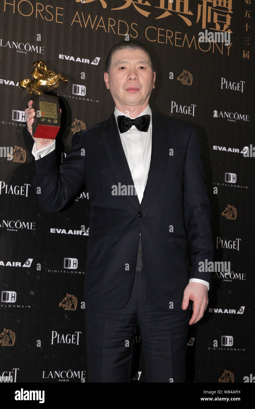 Chinese director Feng Xiaogang poses with his trophy of the Best ...