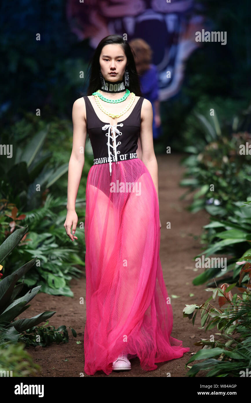 A model displays a new creation at the fashion show of Fiona Chen ...