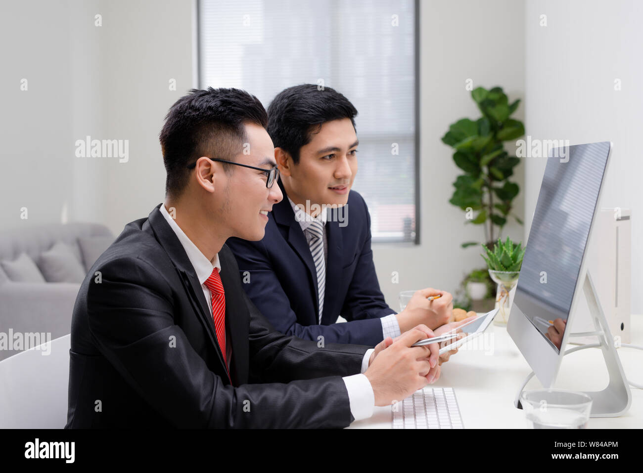 Startup business partners working together in desktop Stock Photo - Alamy