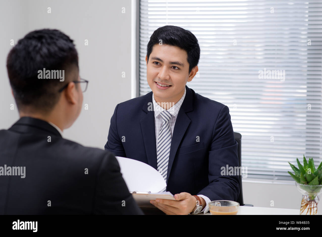 Job interview of two business professionals. Greeting new colleague ...