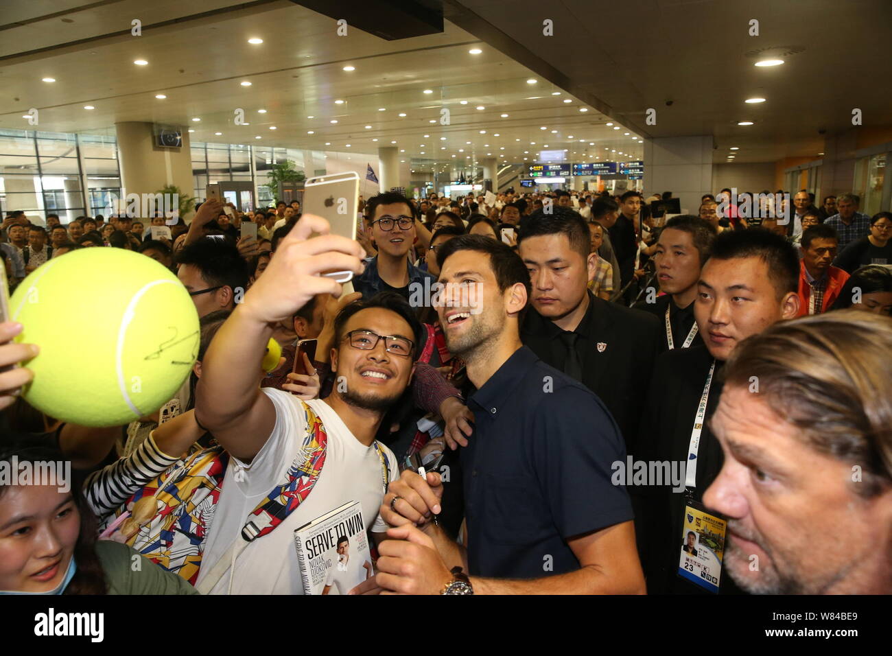 Novak Djokovic of Serbia, center, signs autographs for fans after ...