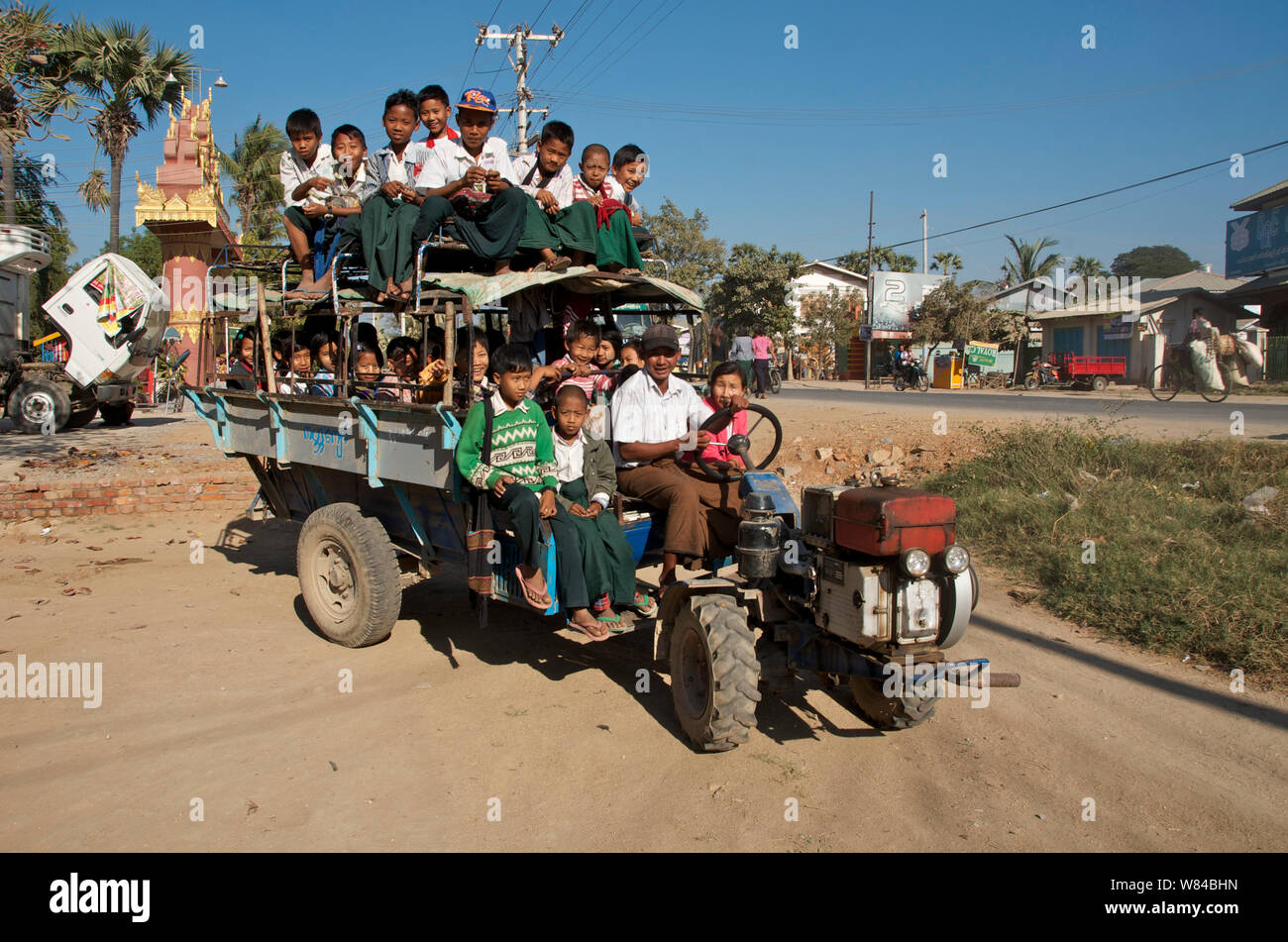Chinese-made tractor serves as a school bus for children in the Burmese ...