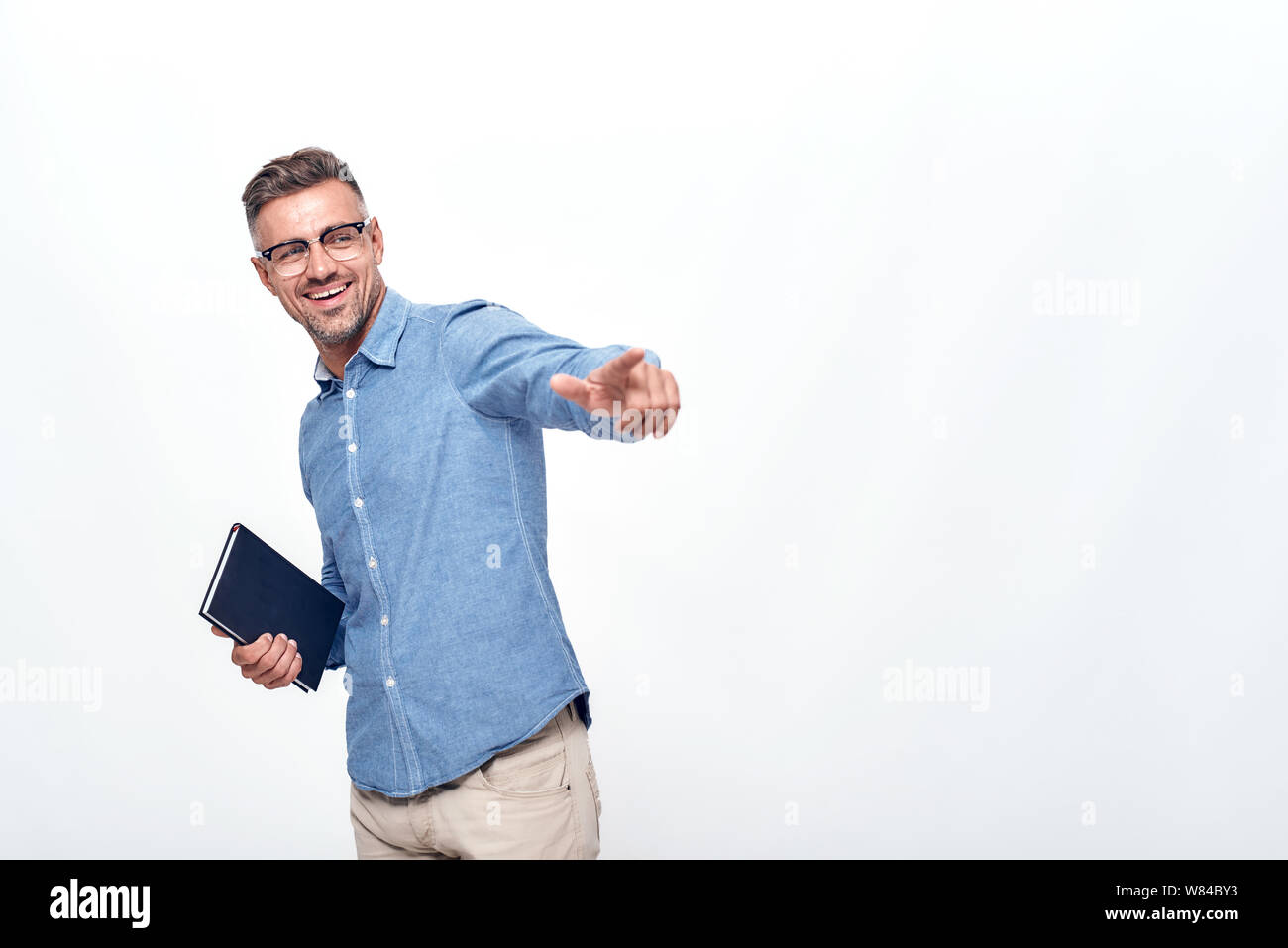 Studio shot of smiling and handsome man with a stubble in eyewear ...