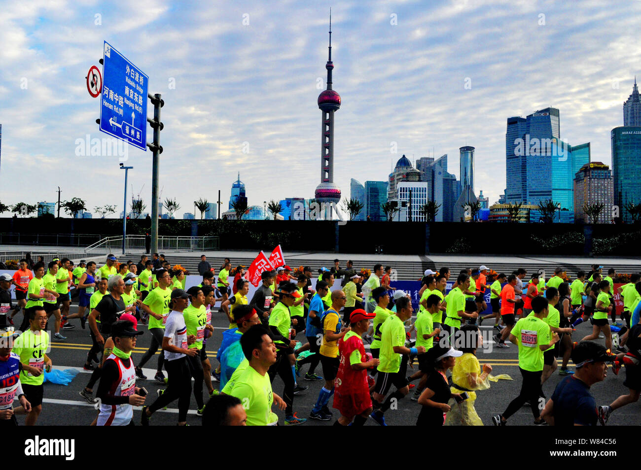 Participants run past colonial buildings along the Bund in the 2016 ...