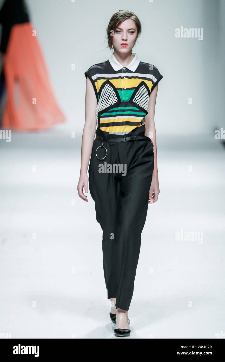 A model displays a new creation at the fashion show of Complementair during the Shanghai Fashion ...