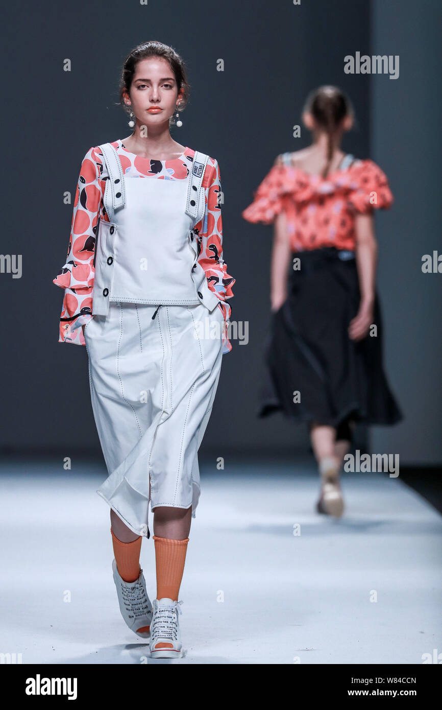A model displays a new creation at the fashion show of Tang Xiaofu ...