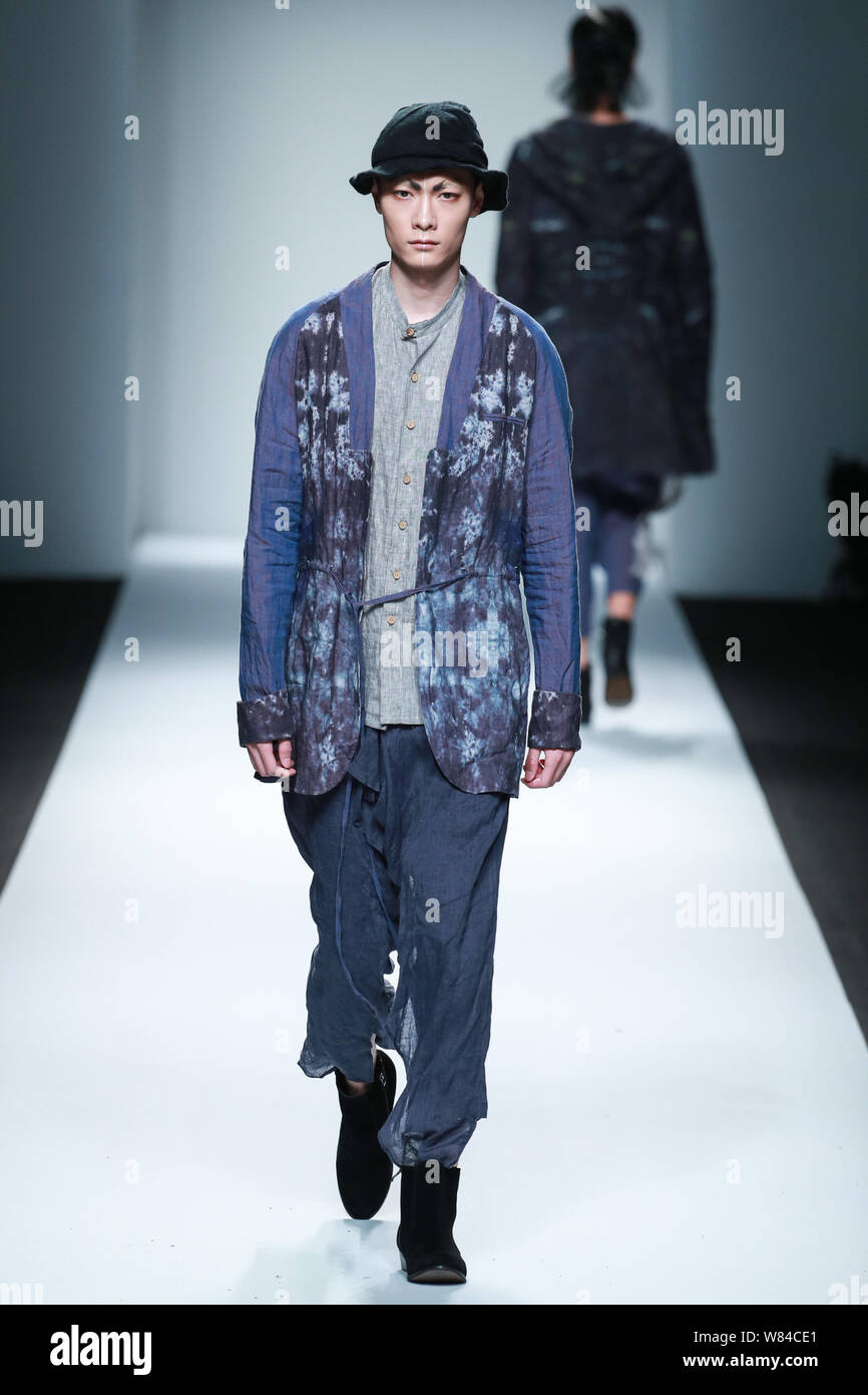 A model displays a new creation at the fashion show of Xinshen Linen ...