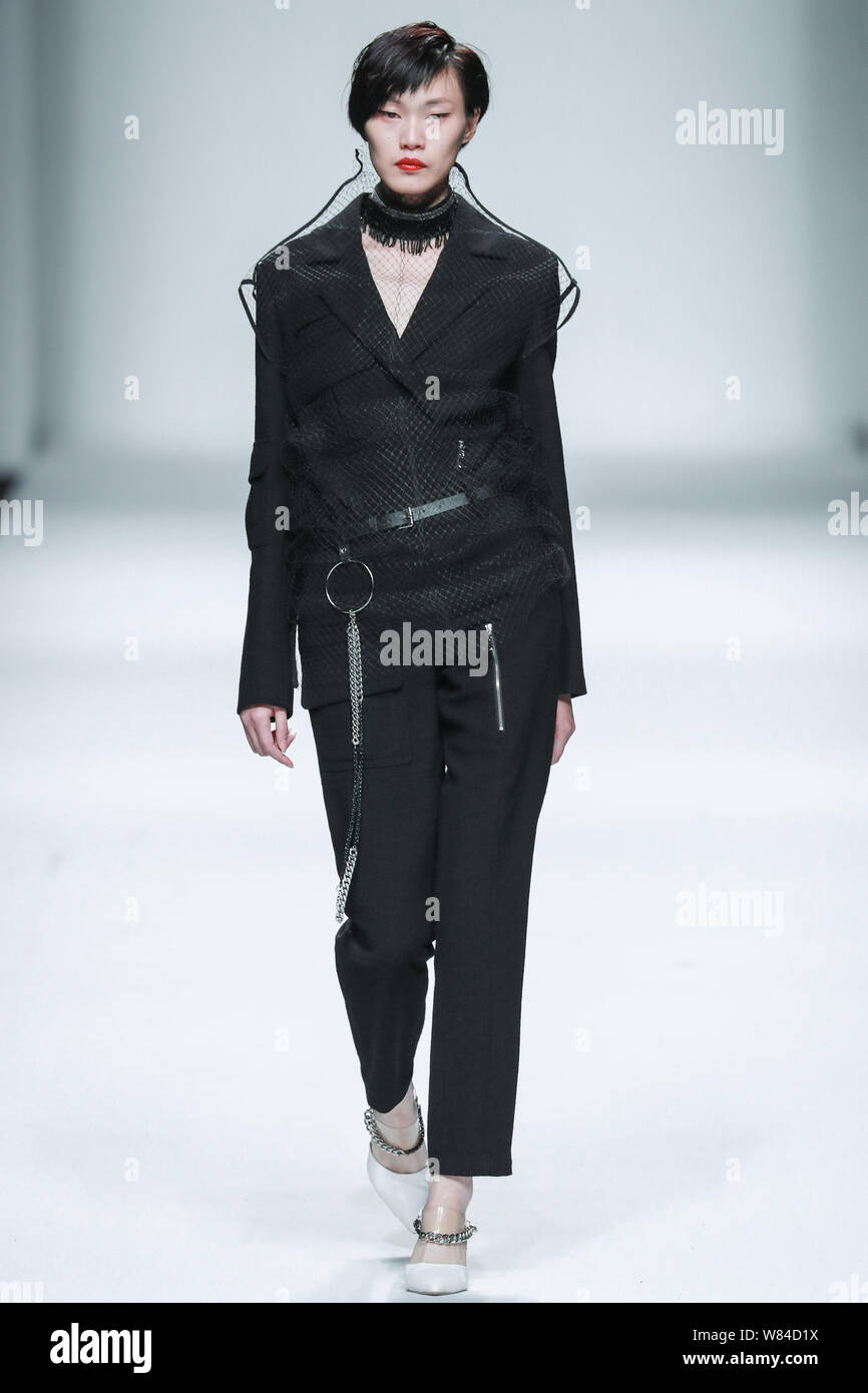 A model displays a new creation at the fashion show of Complementair during the Shanghai Fashion ...