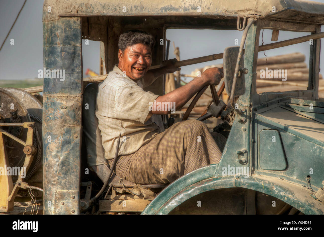 a smiling driver driving his old truck Stock Photo - Alamy