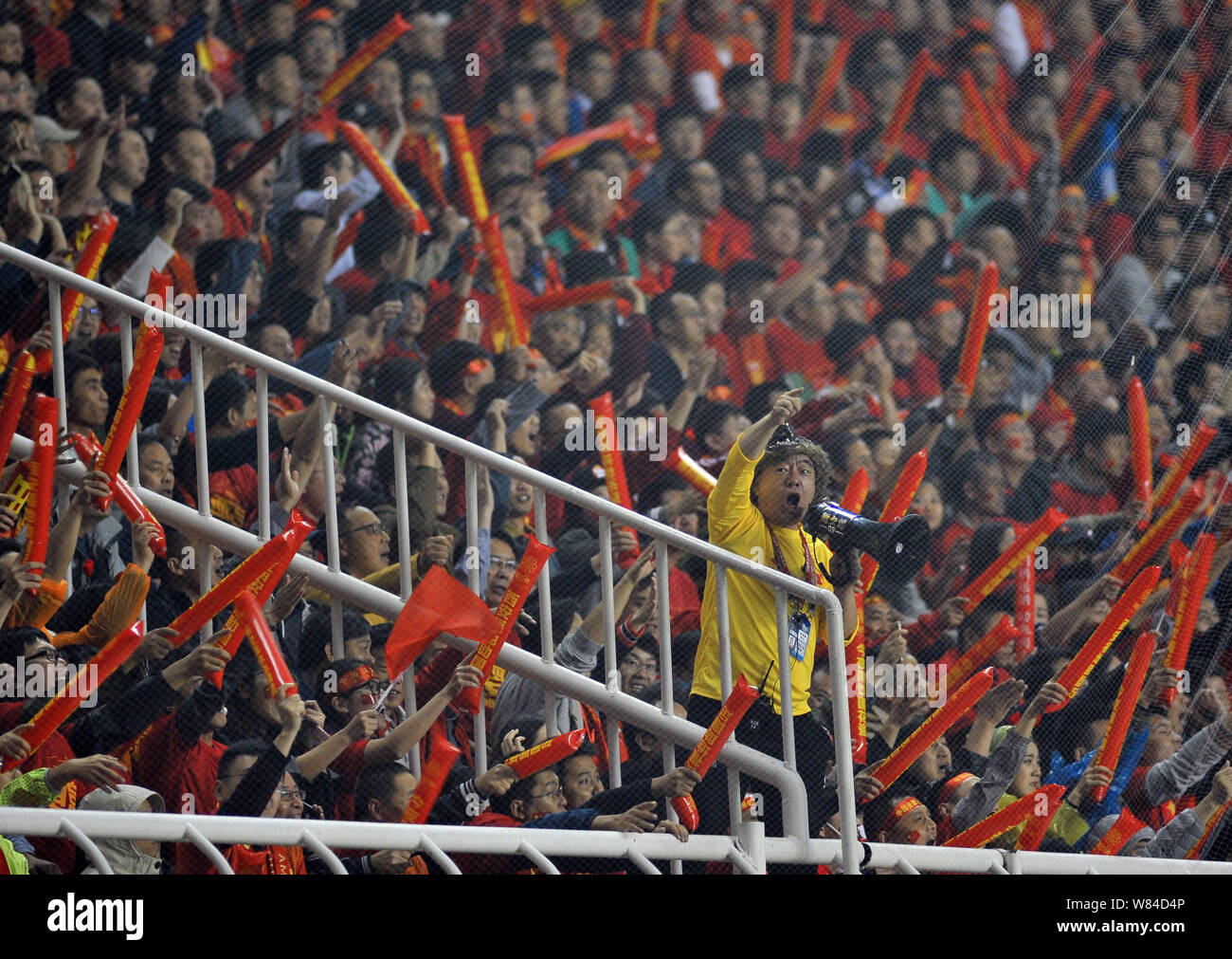 Chinese football fans shout slogans to show support for the Chinese ...