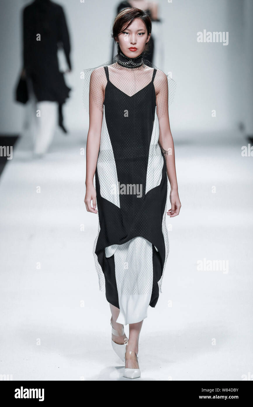 A model displays a new creation at the fashion show of Complementair during the Shanghai Fashion ...