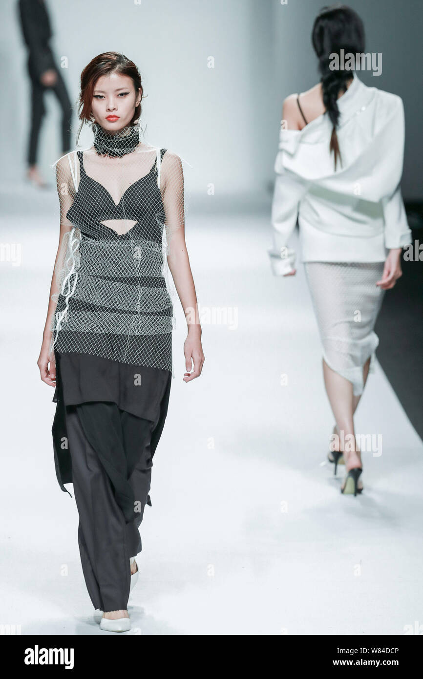A model displays a new creation at the fashion show of Complementair during the Shanghai Fashion ...