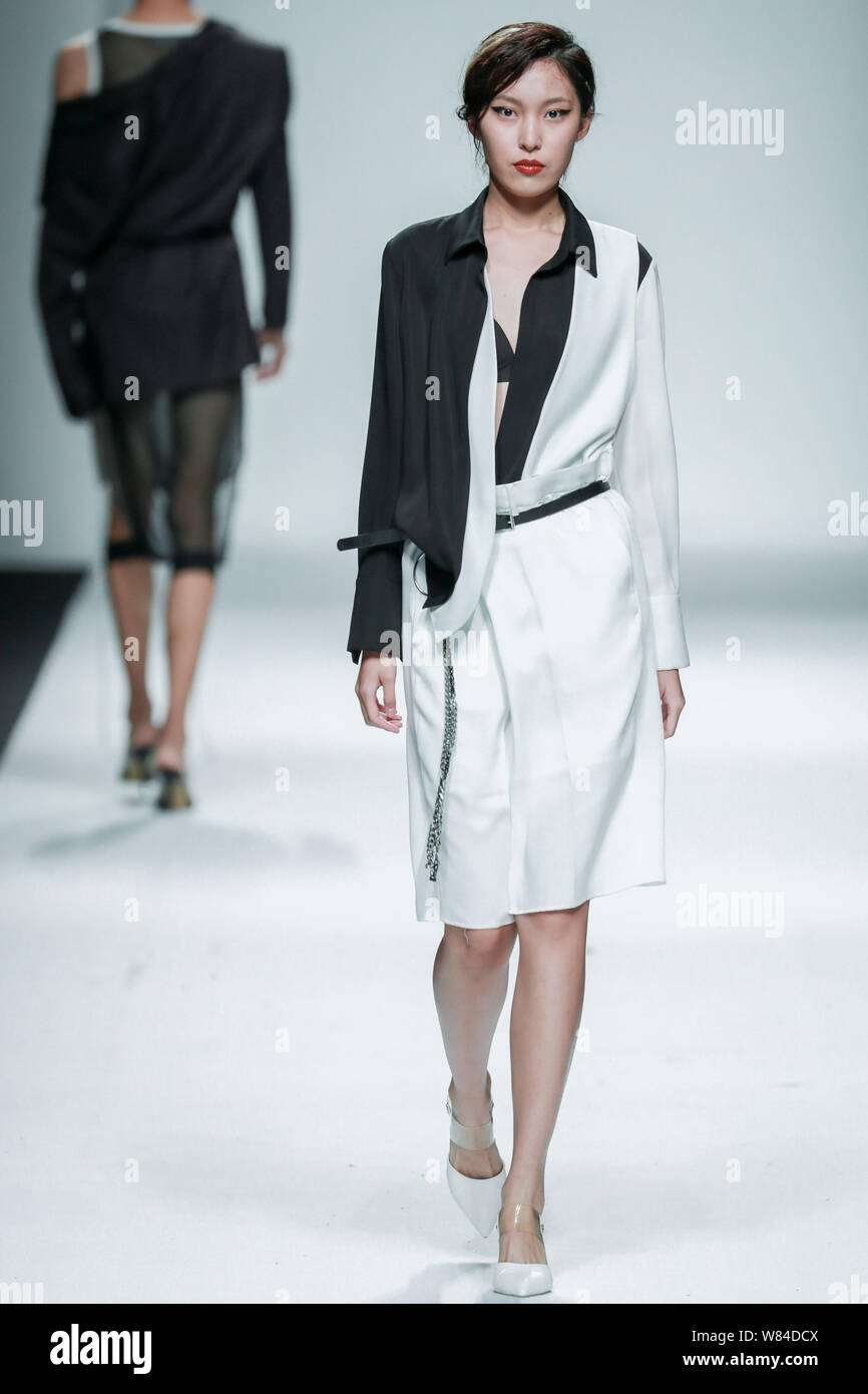 A model displays a new creation at the fashion show of Complementair during the Shanghai Fashion ...