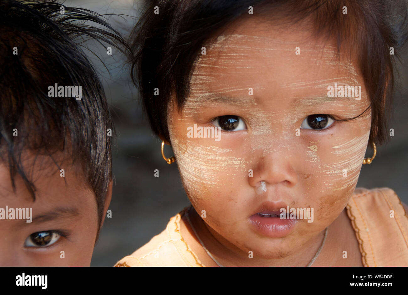 portrait of a young Burmese girl with makeup face of Thanaka on the shore of the Irrawaddy Stock ...