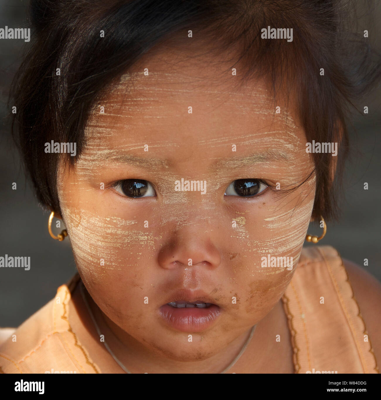 portrait of a young Burmese girl with makeup face of Thanaka on the shore of the Irrawaddy Stock ...