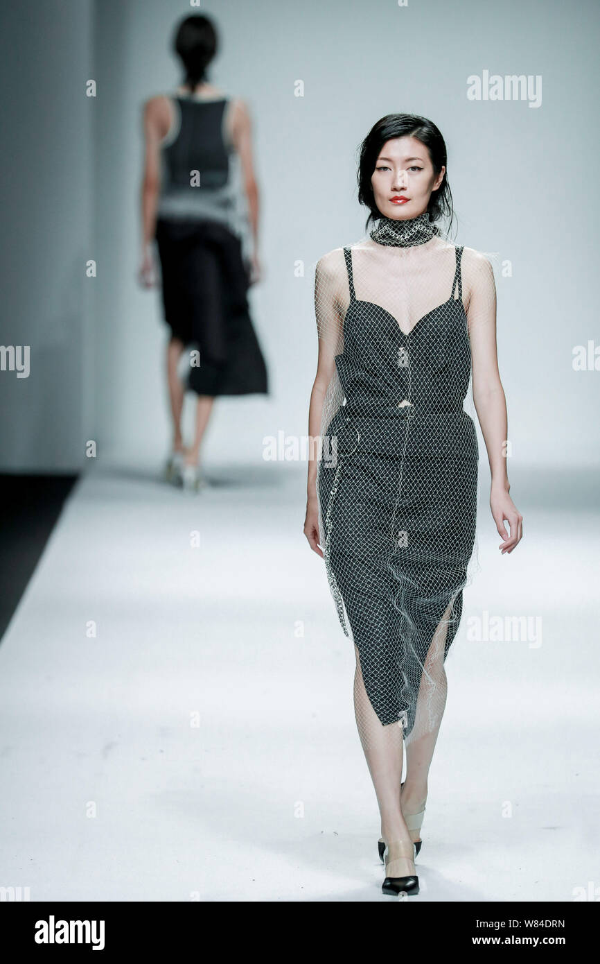 A model displays a new creation at the fashion show of Complementair during the Shanghai Fashion ...