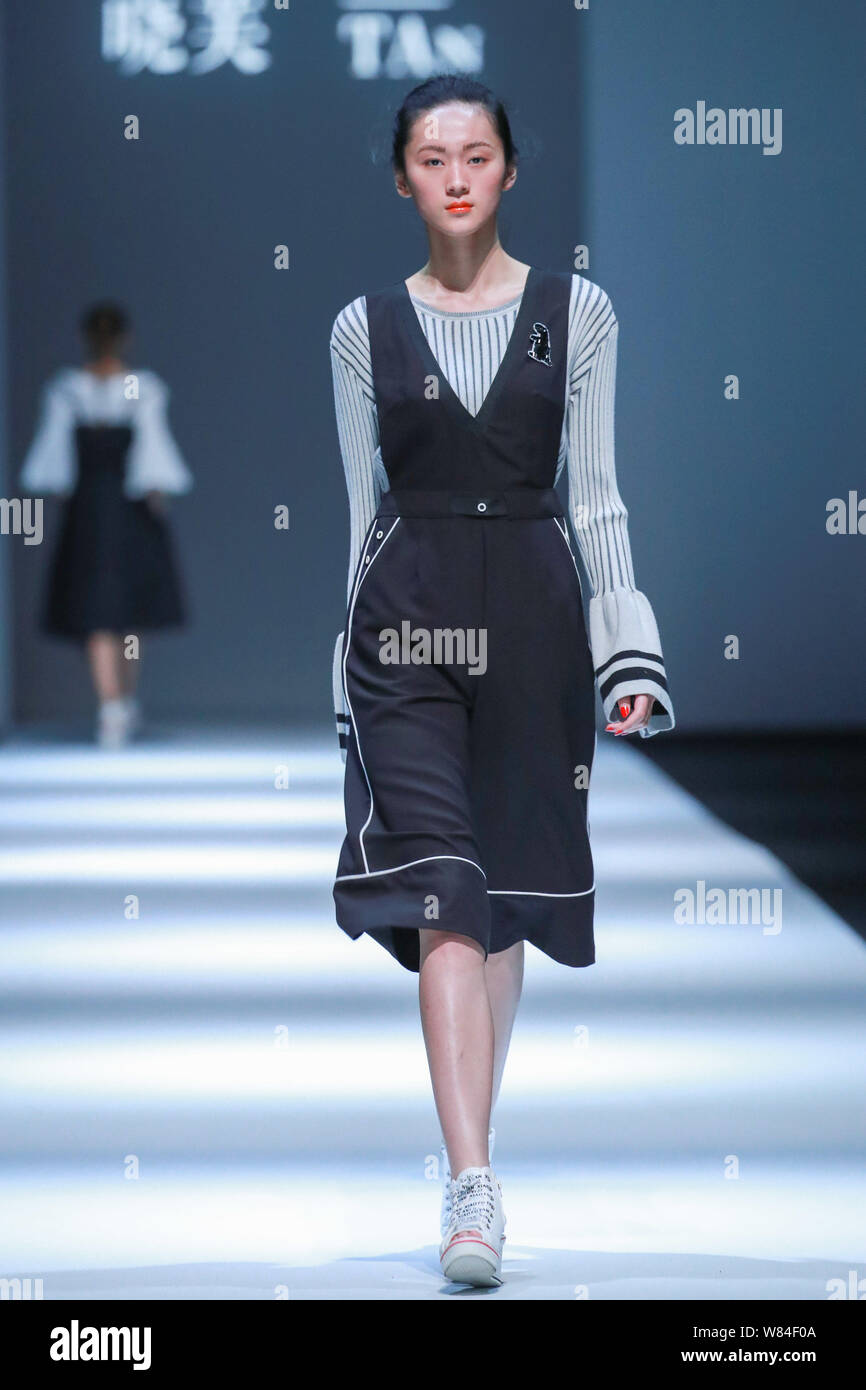 A model displays a new creation at the fashion show of Tang Xiaofu ...