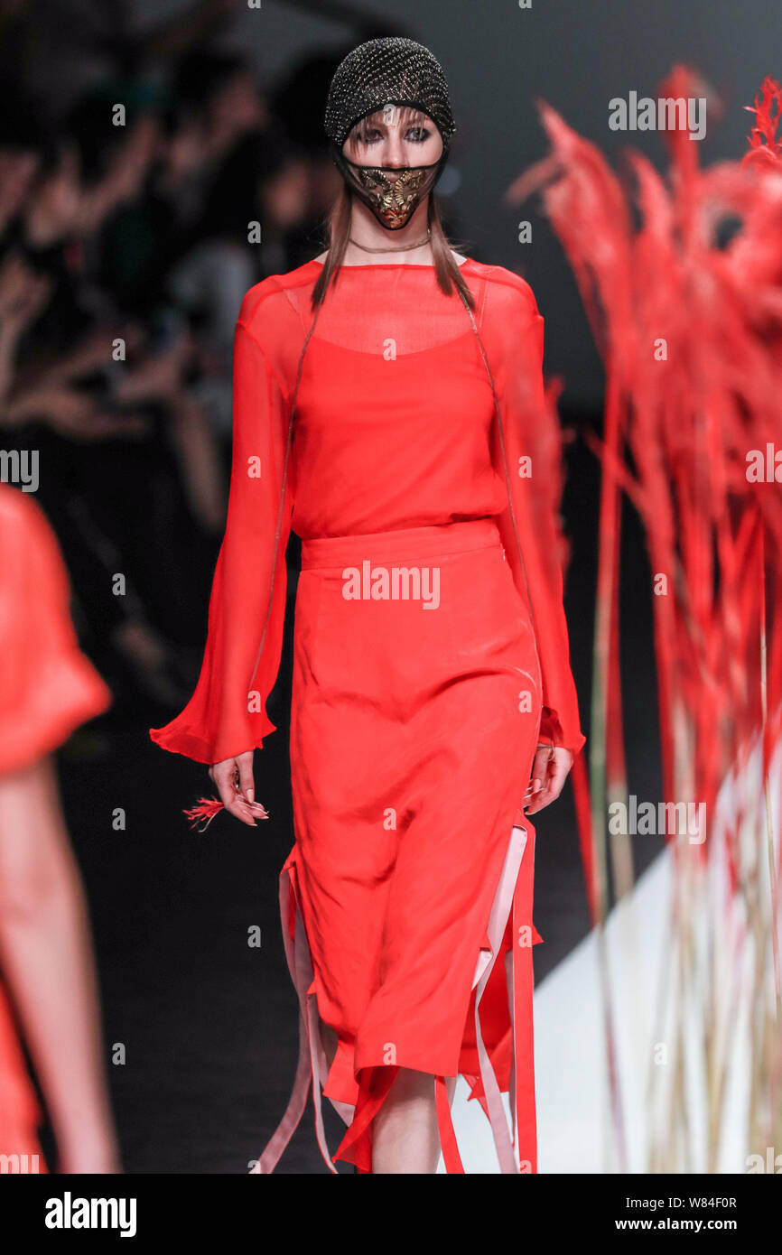 A model displays a new creation at the fashion show of Ji Cheng during ...