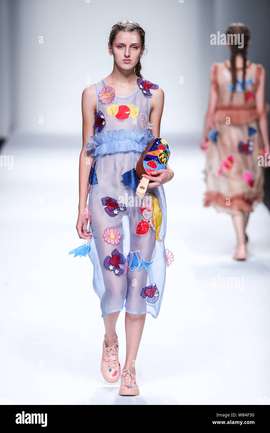 A model displays a new creation at a fashion show of Leaf Xia during ...