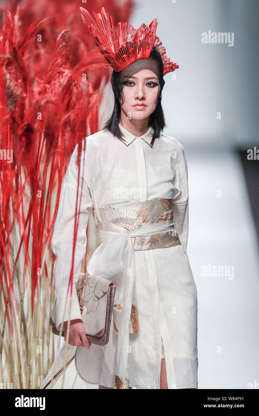 A model displays a new creation at the fashion show of Ji Cheng during ...