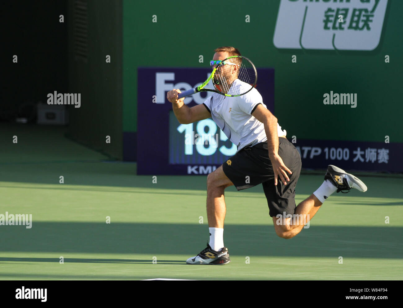 Viktor Troicki of Serbia returns a shot to Lukas Rosol of Czech ...