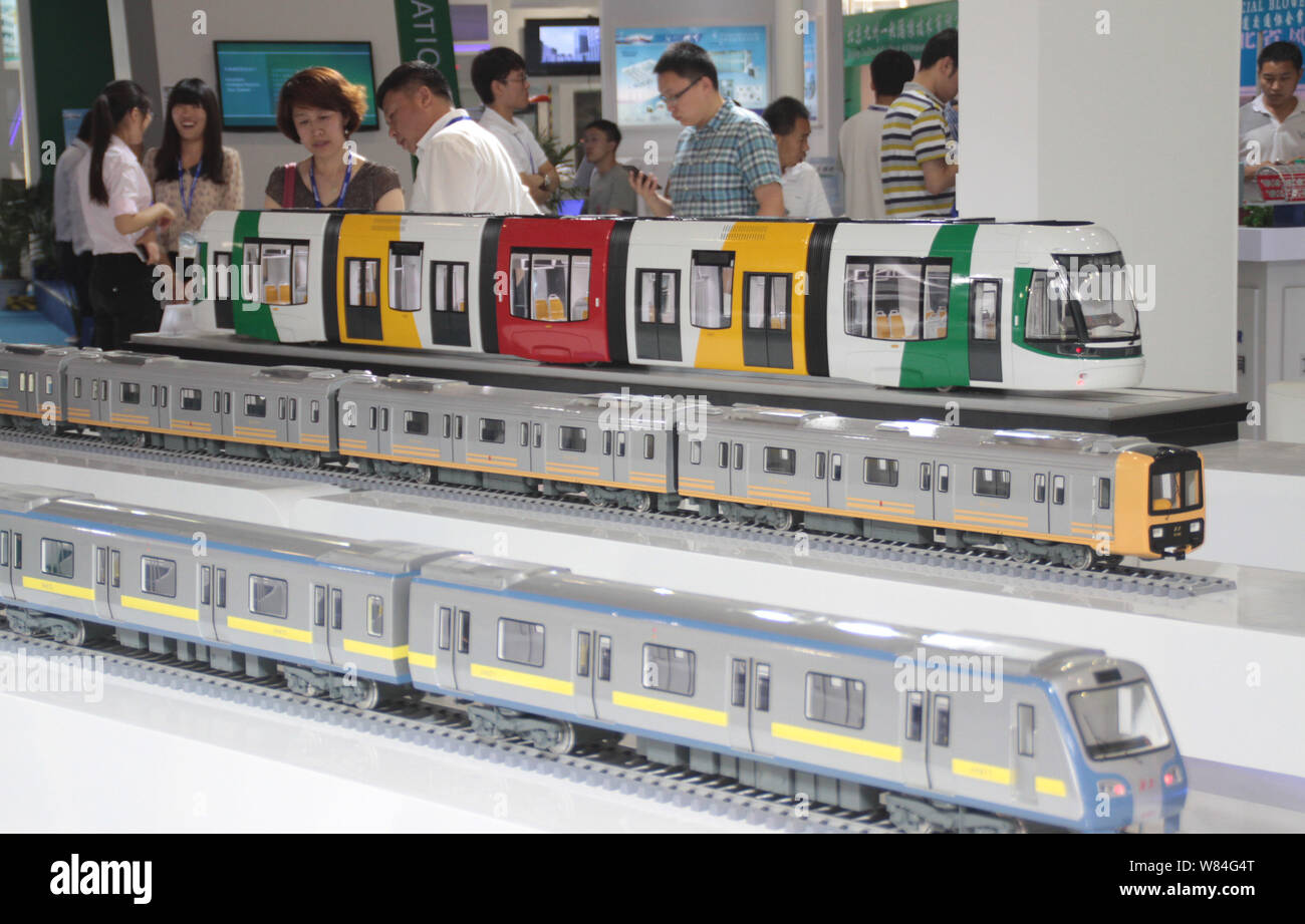 --FILE--Visitors look at model metro trains on display during the ...