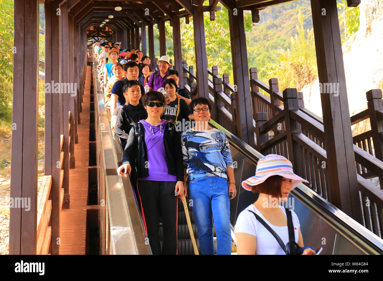 Tourists take the world's longest sightseeing escalator in the Enshi ...