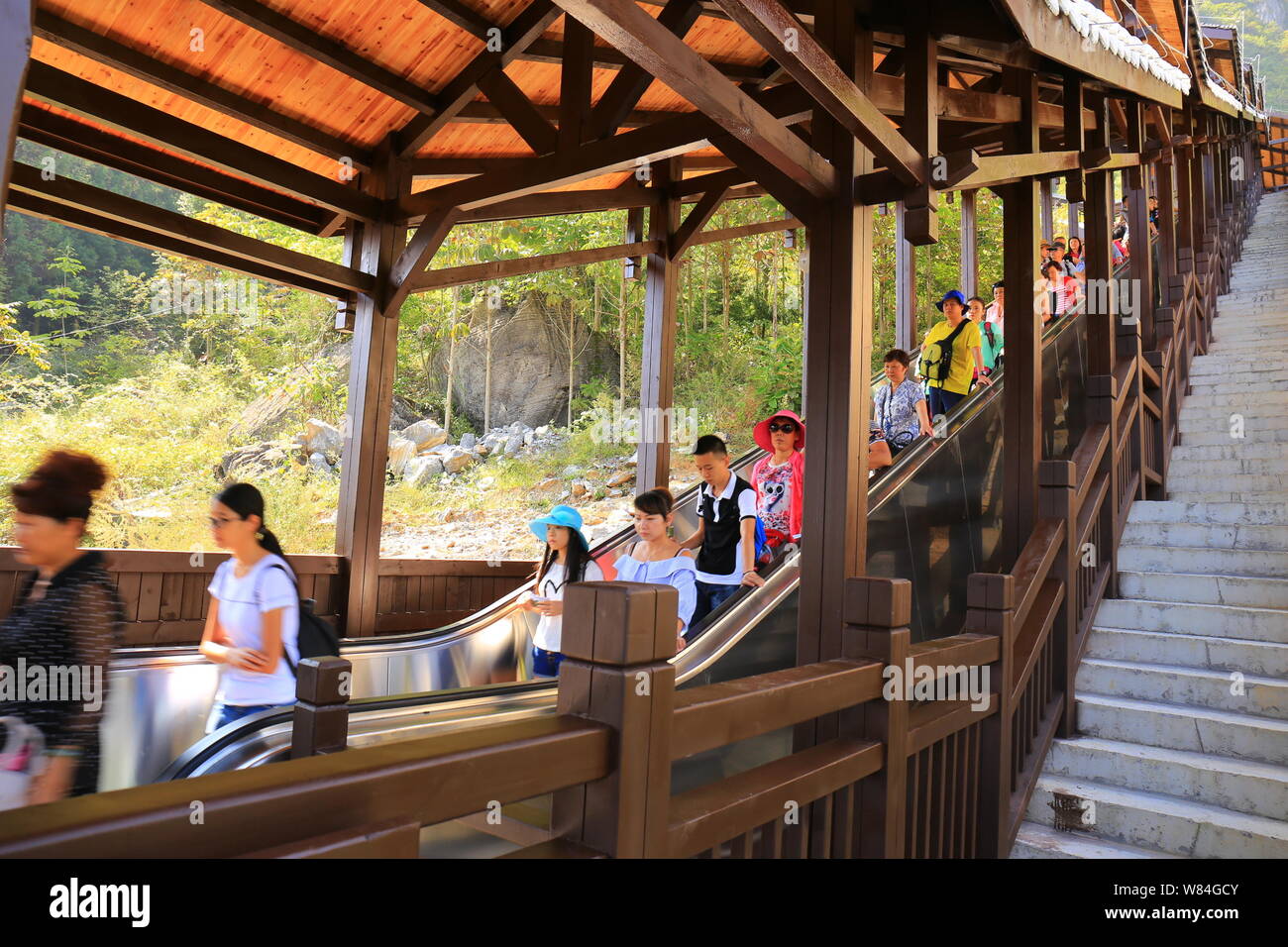 Tourists take the world's longest sightseeing escalator in the Enshi ...