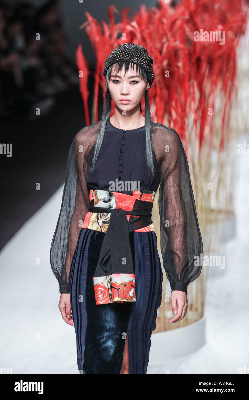 A model displays a new creation at the fashion show of Ji Cheng during ...