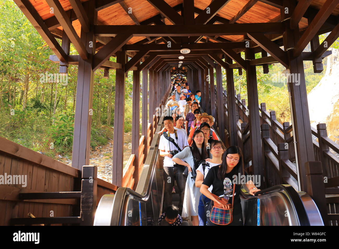 Tourists take the world's longest sightseeing escalator in the Enshi ...