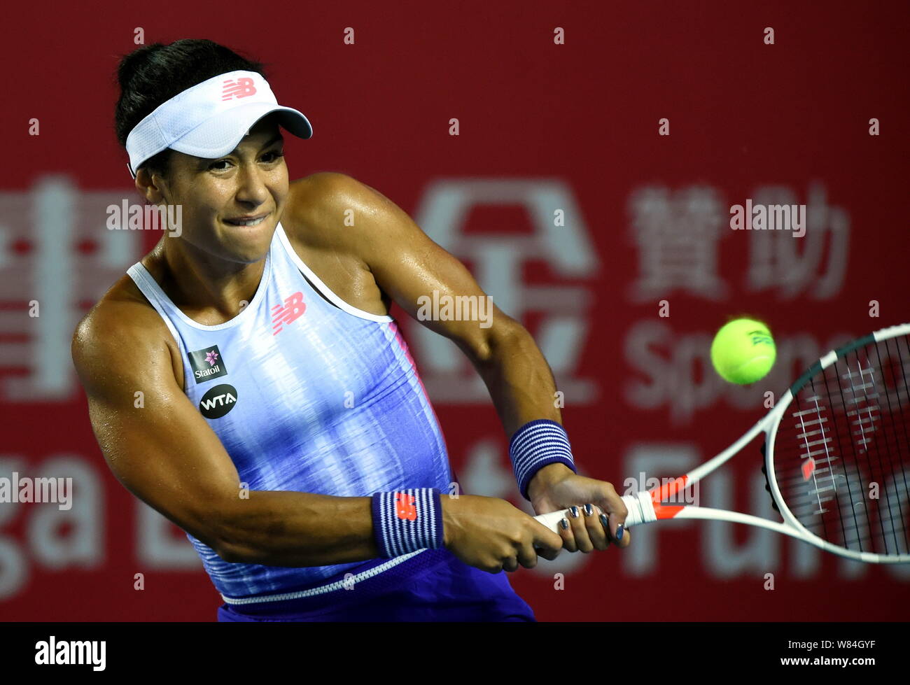 Heather Watson of Great Britain returns a shot to Caroline Wozniacki of ...