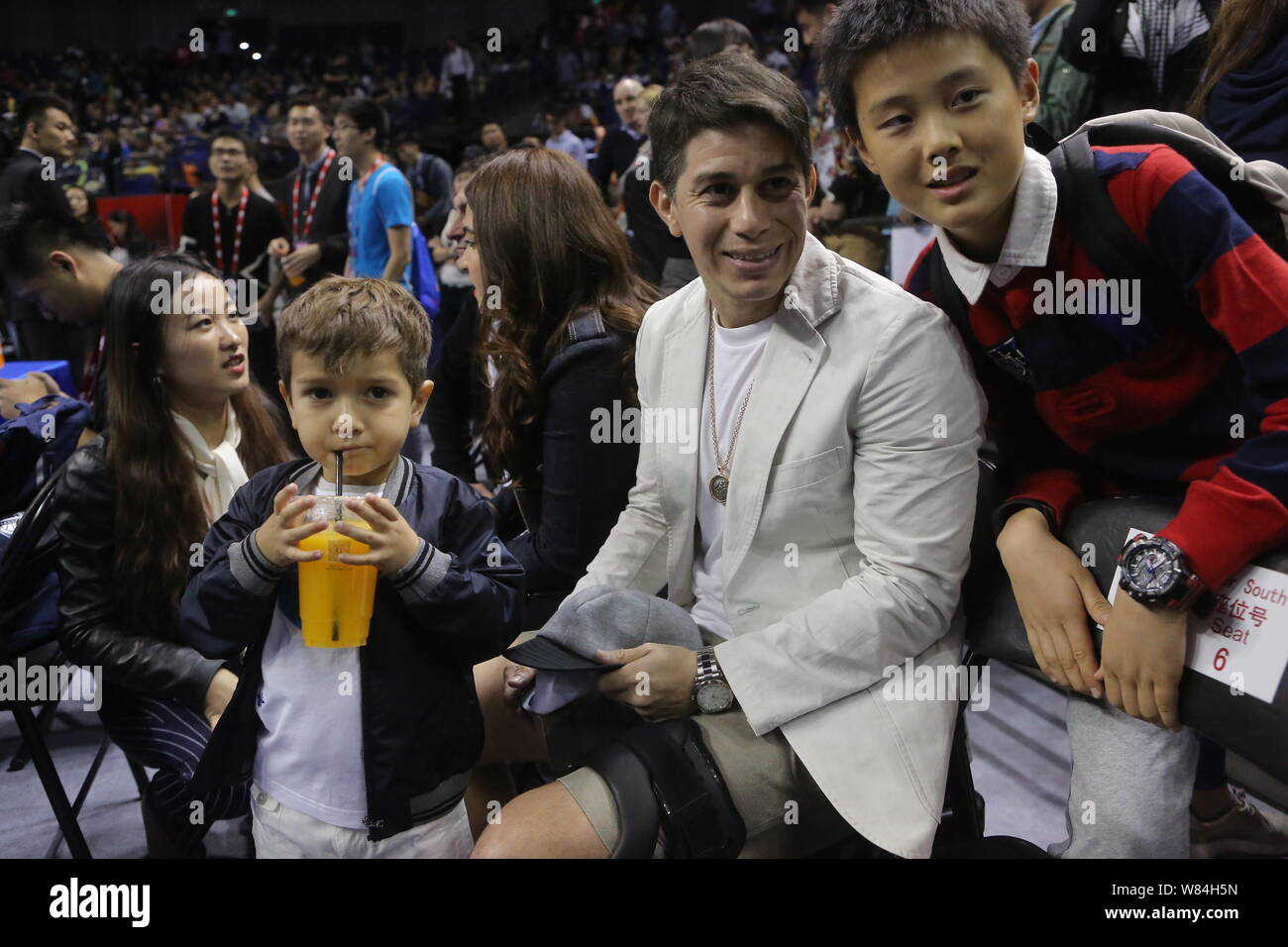 Argentine football star Dario Conca, center, and his son Benjamin pose ...