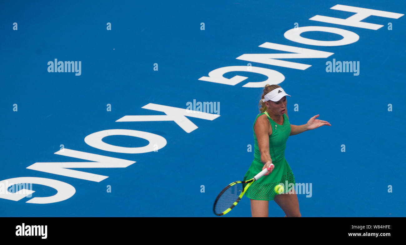Caroline Wozniacki of Denmark returns a shot to Zheng Saisai of China ...