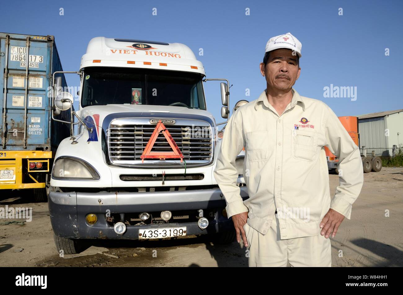 Vietnamese truck driver poses proudly in front of his American-made ...